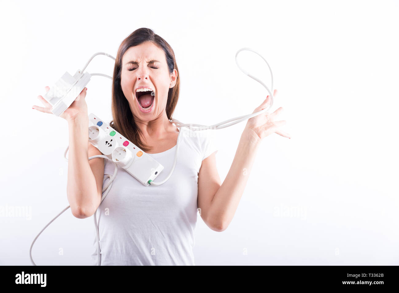 A beautiful young woman screaming with power cables in her hands Stock ...