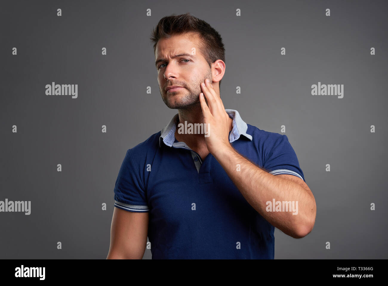A handsome young man checking the skin on his face Stock Photo - Alamy