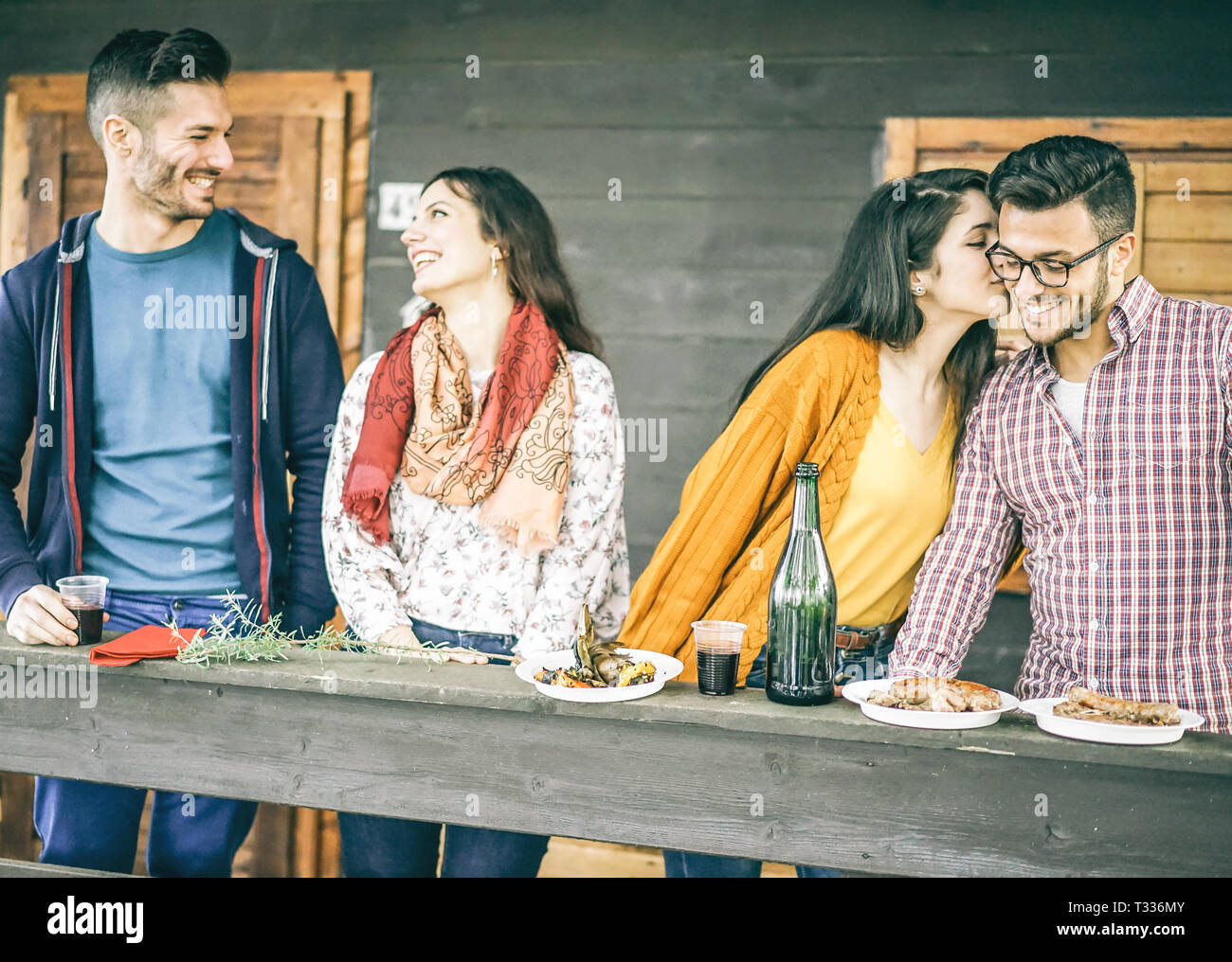 Happy friends having a lunch at backyard eating grilled meat and ...