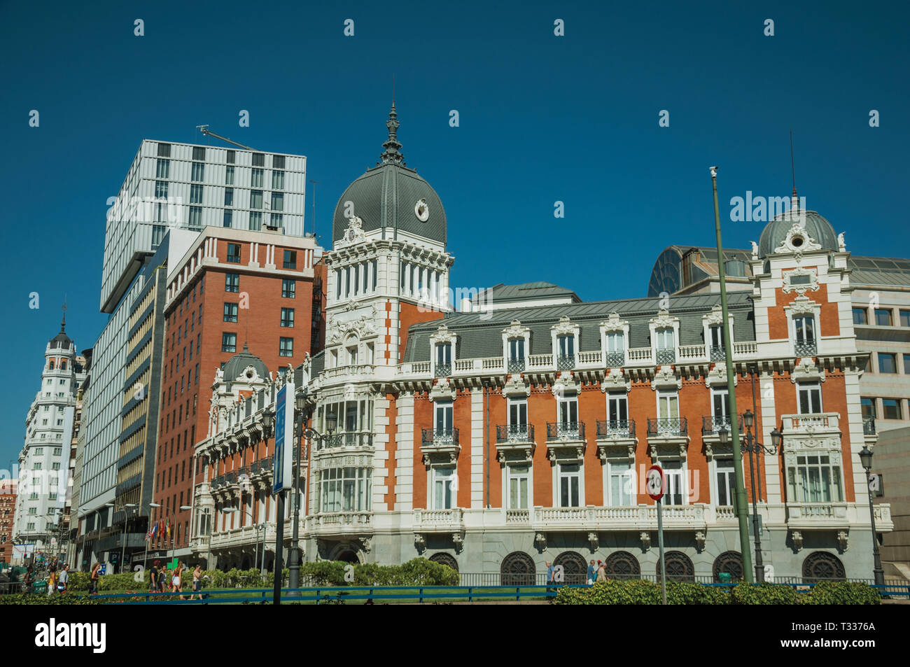 Colorful building with flamboyant facade and people walking on street ...