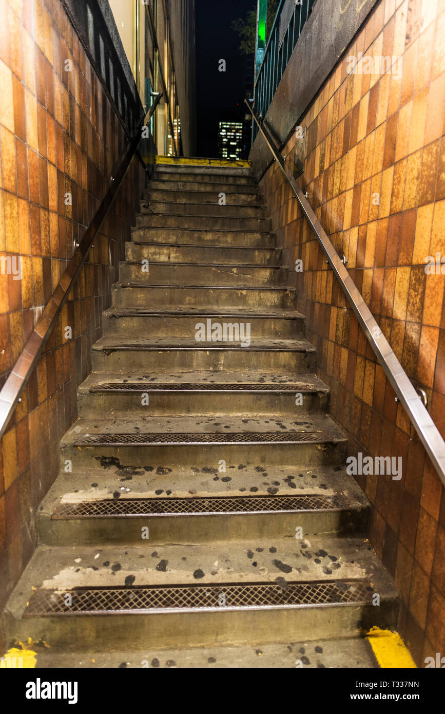 Old and worn stairs in subway station at night in New York City, USA ...