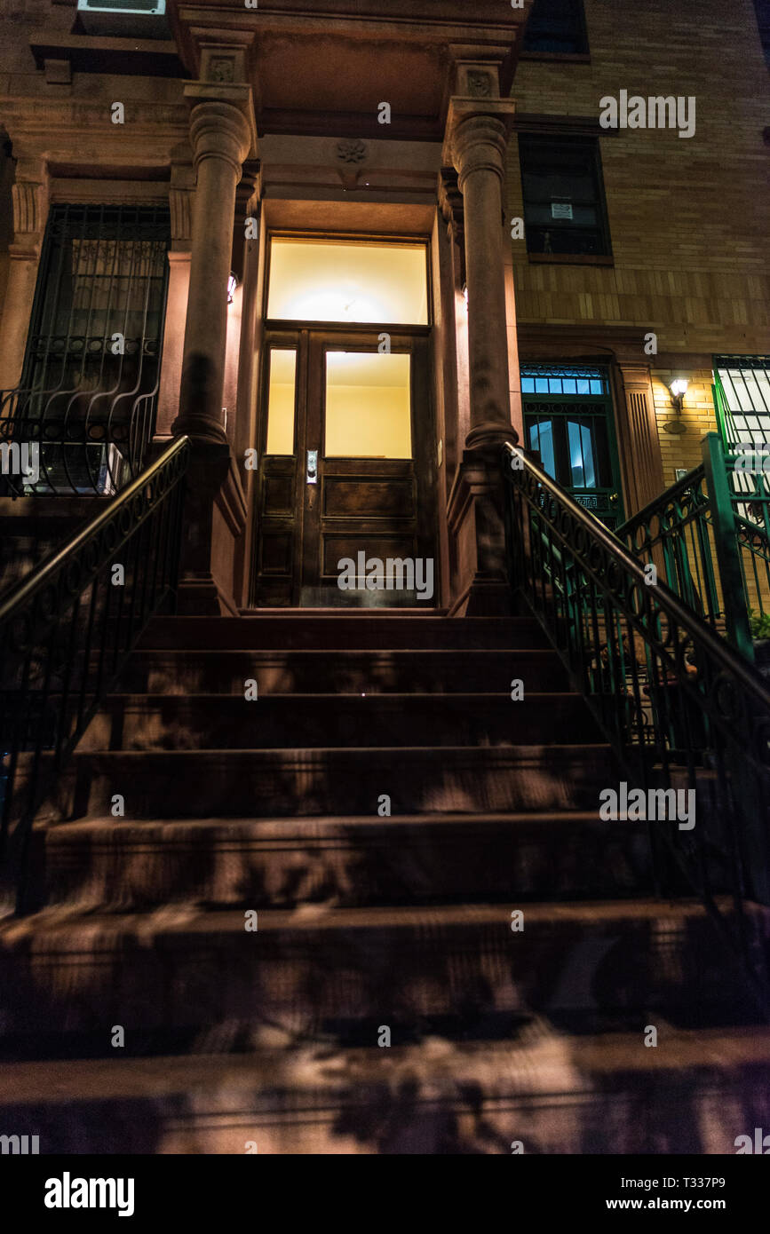 Entrance of an old typical house at night in the Harlem neighborhood in ...