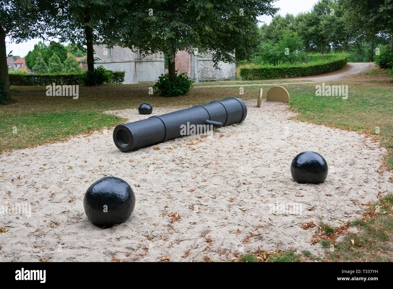 the barrel of an old cannon with three cannon balls Stock Photo - Alamy