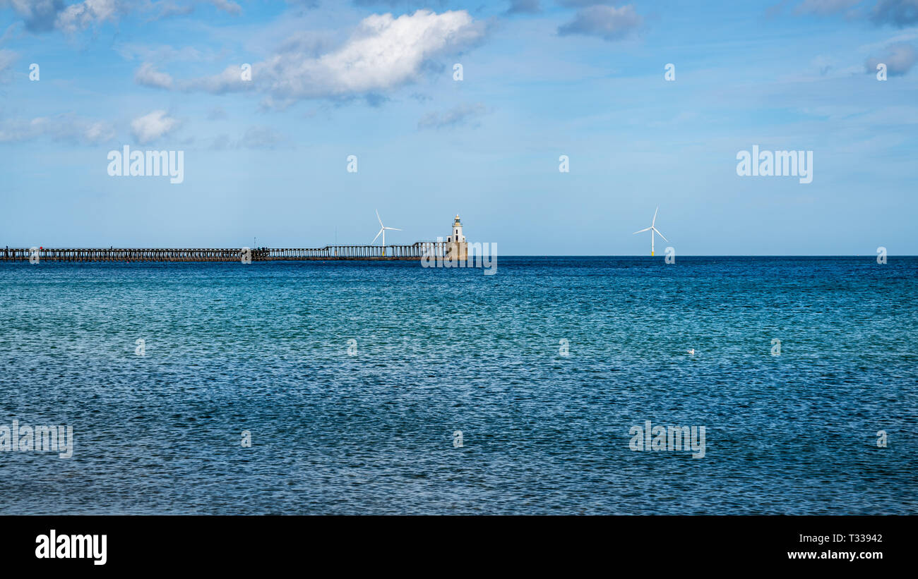 Blyth Lighthouse, the pier and a wind turbine on the North Sea Coast ...