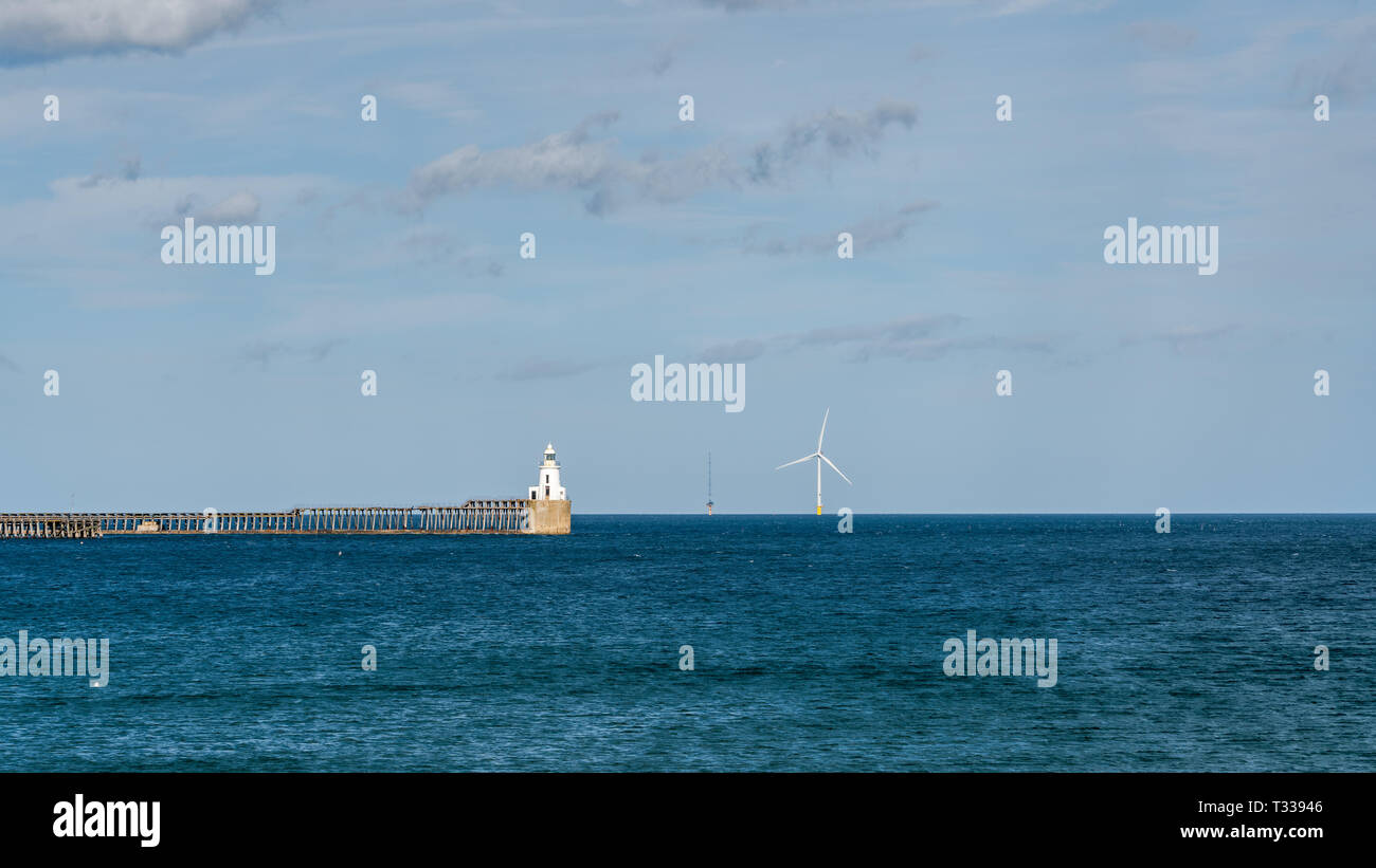Blyth Lighthouse, the pier and a wind turbine on the North Sea Coast ...