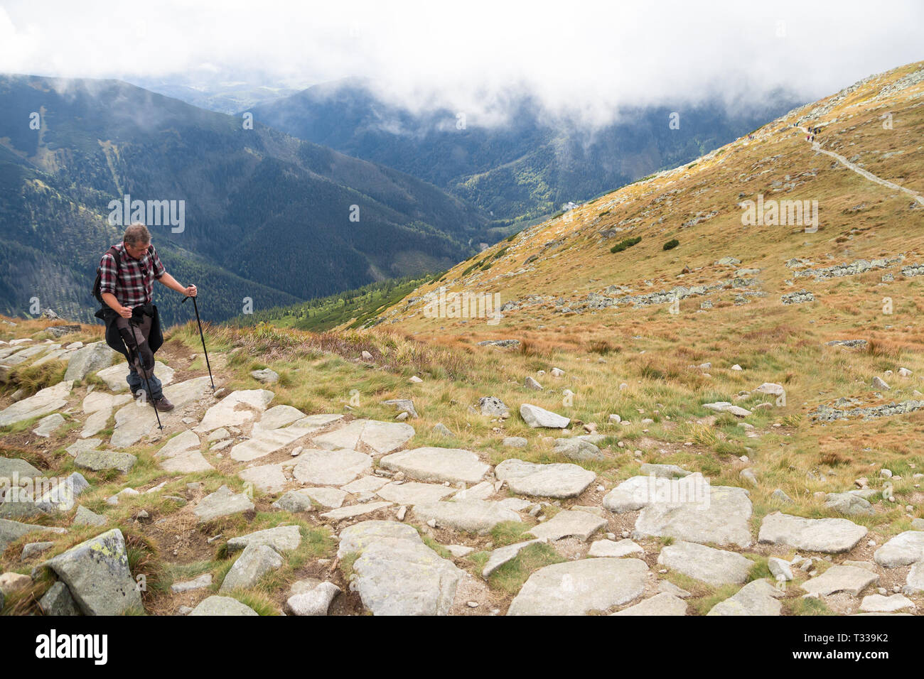 tourist hiker walking tourist road on mountain ridge Stock Photo - Alamy