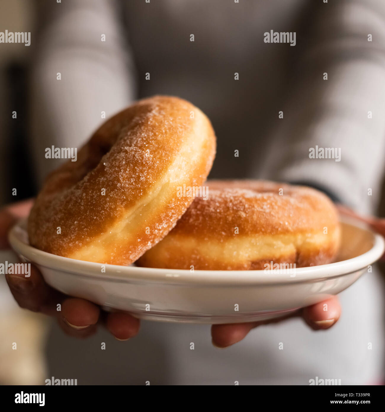 take a donut by woman's hand in house Stock Photo - Alamy