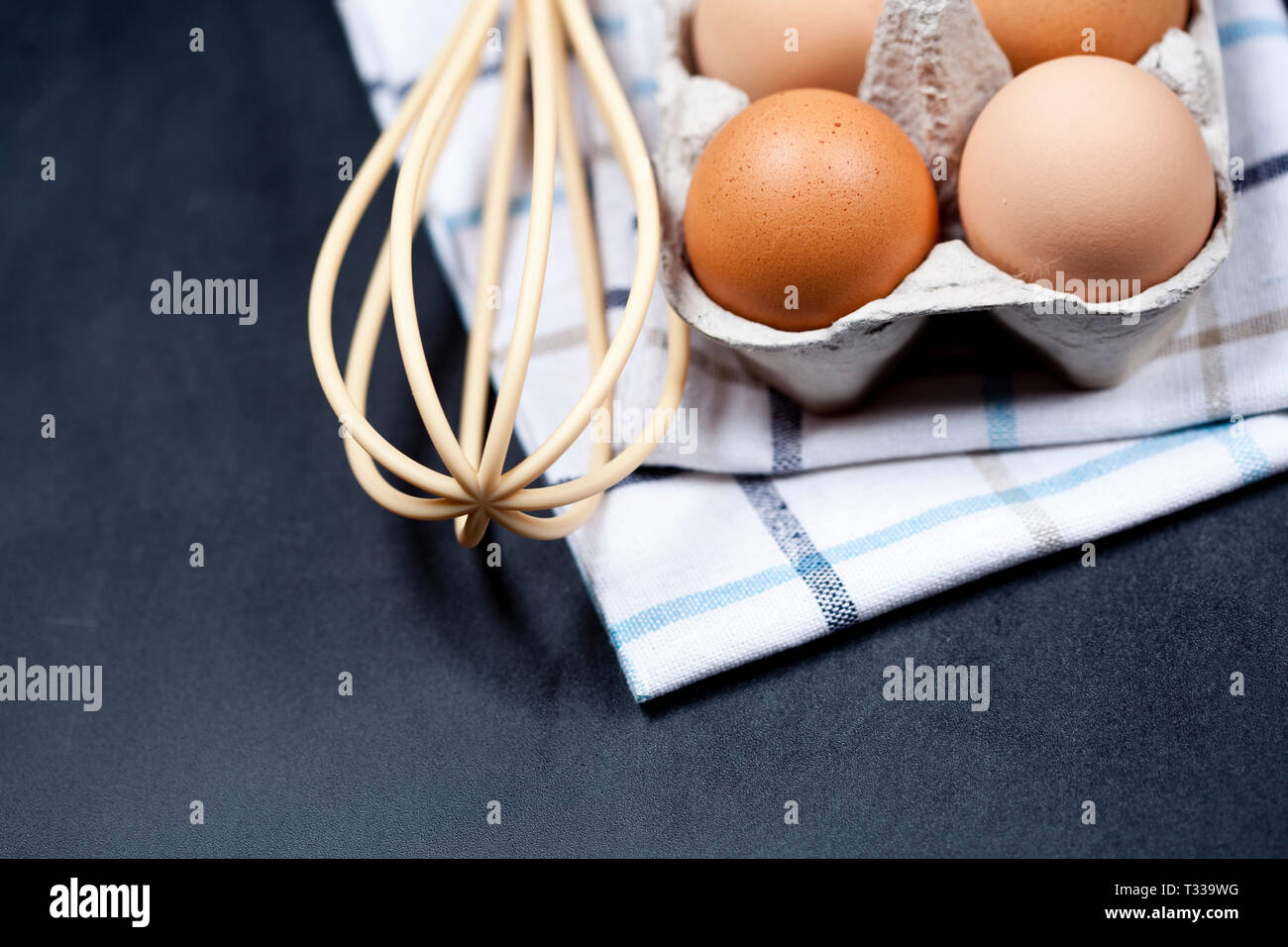 Eggs in cardboard box, towel and whisker closeup on backboard ...