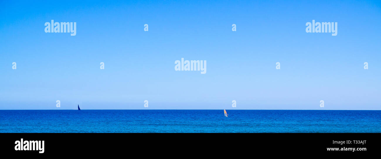 Panoramic view of sea skyline, two sails on horizon, minimalistic style ...