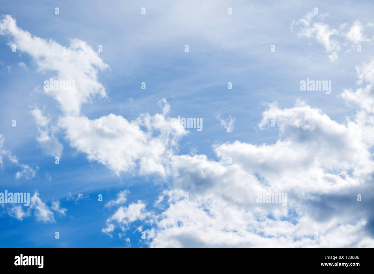 Blue sky background with white dramatic colorful clouds and sunlight ...