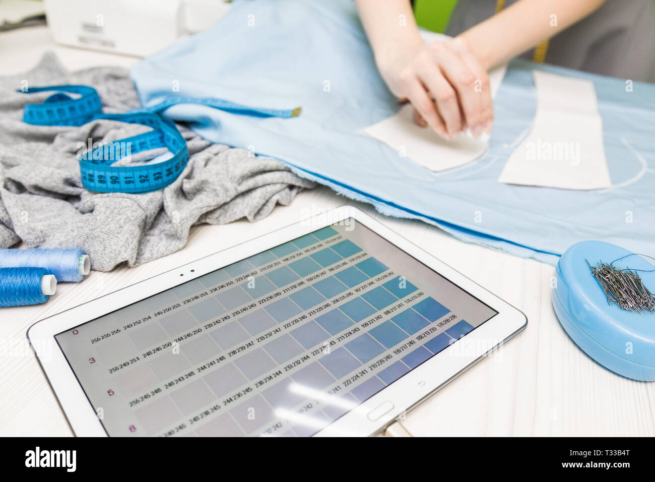 Sewing workshop. Seamstress at work. Marking and cutting fabric Stock ...
