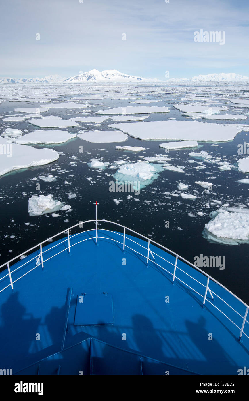 An ice strengthened Antarctic cruise ship pushing through sea ice near ...
