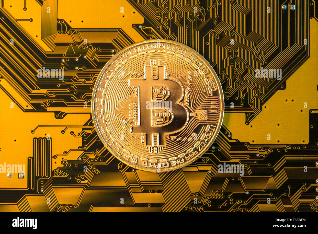 Mining Bitcoin concept - ,gold coin on a yellow PCB Stock Photo - Alamy