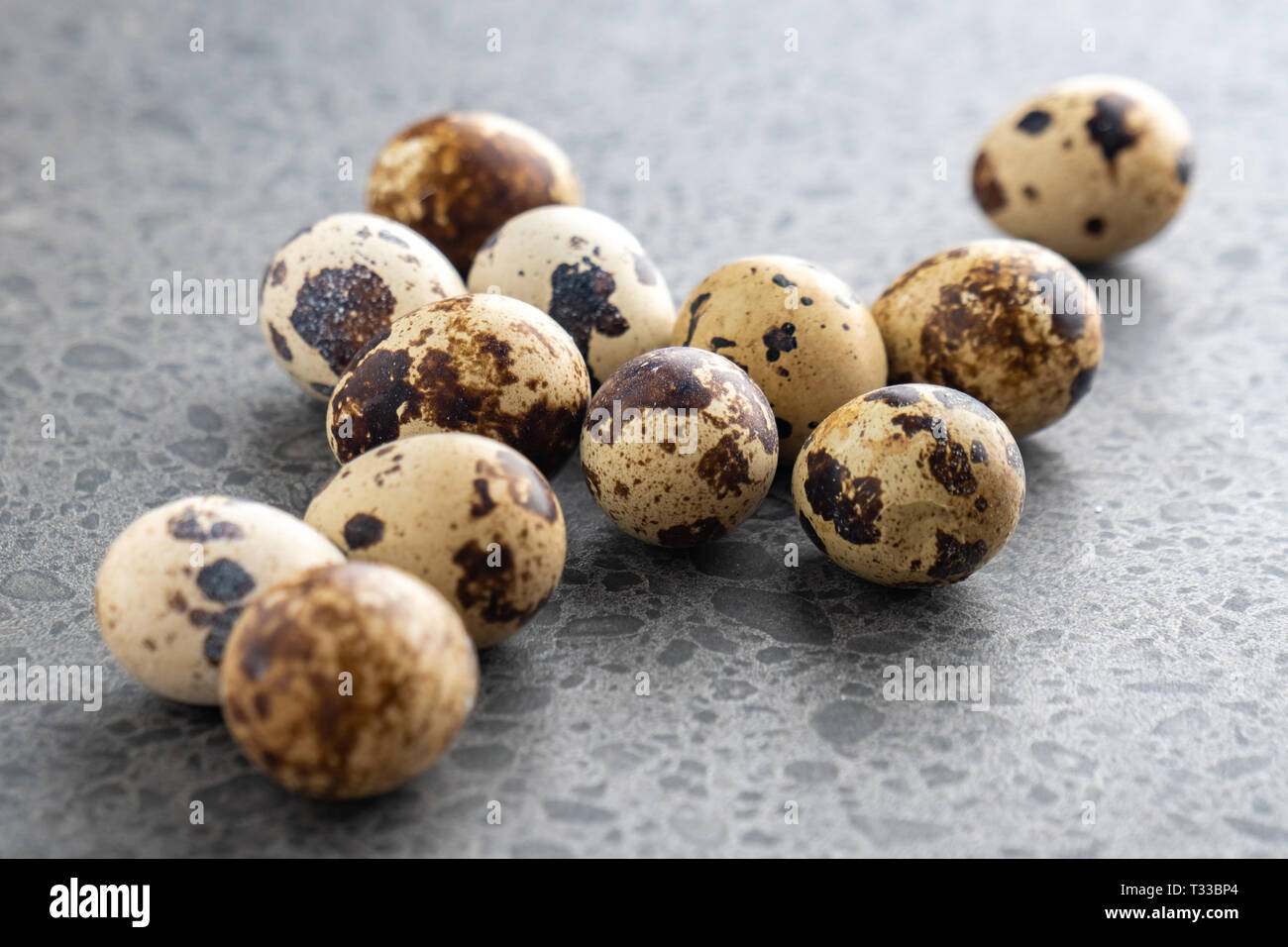 Small quail eggs on the stone background, eco product Stock Photo - Alamy