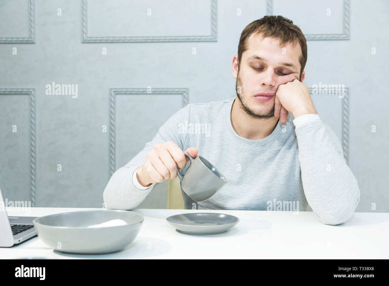 Young handsome man falls asleep at breakfast in the kitchen Stock Photo ...