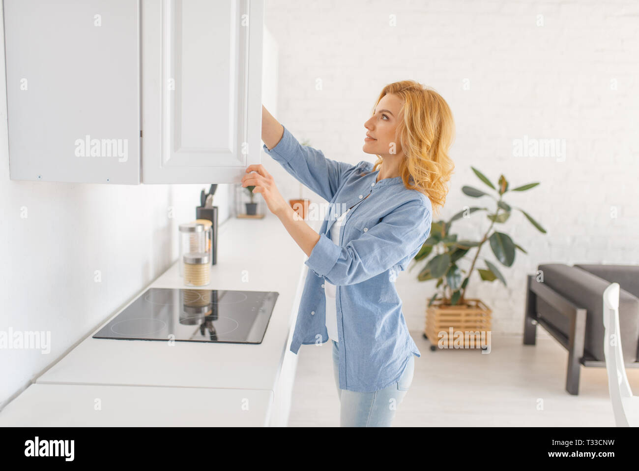 Happy woman prepares to cook fresh breakfast on the kitchen. Female ...
