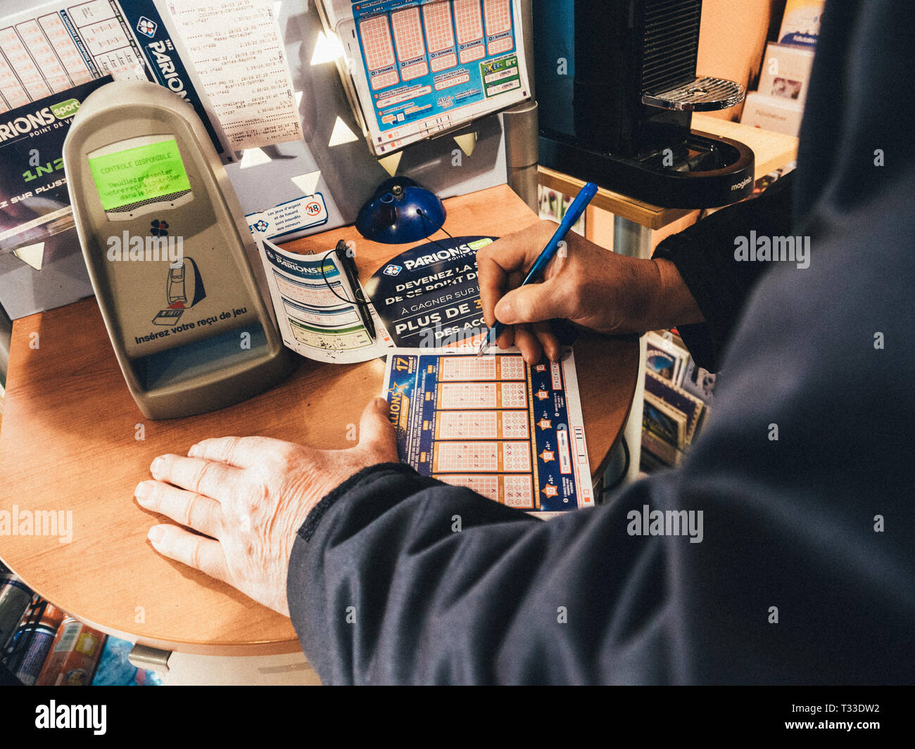 Paris, France - 29 Mar 2019: Senior male hands marking numbers on ...