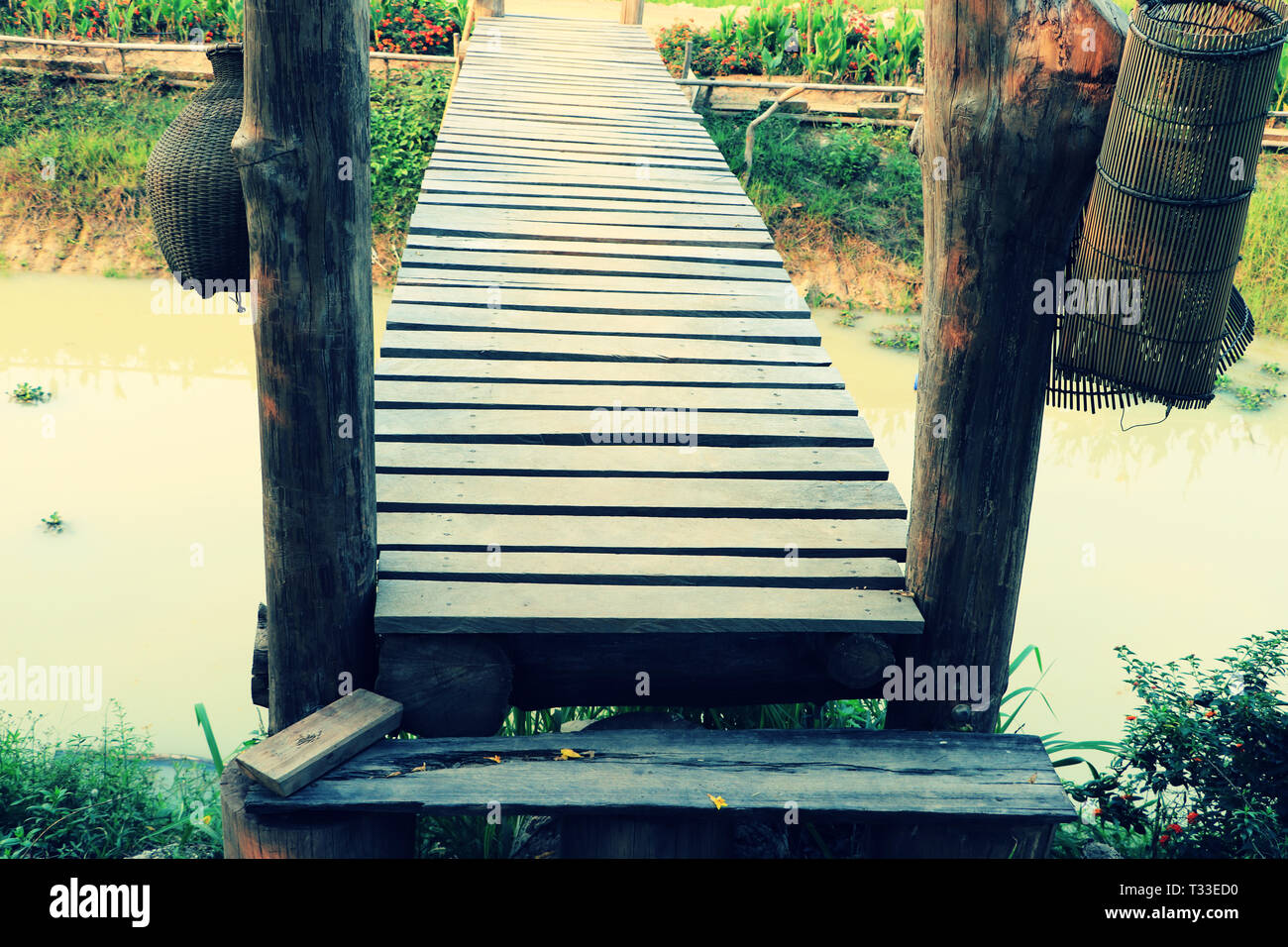 Old wooden bridge crossing the agricultural channel decorated with ...