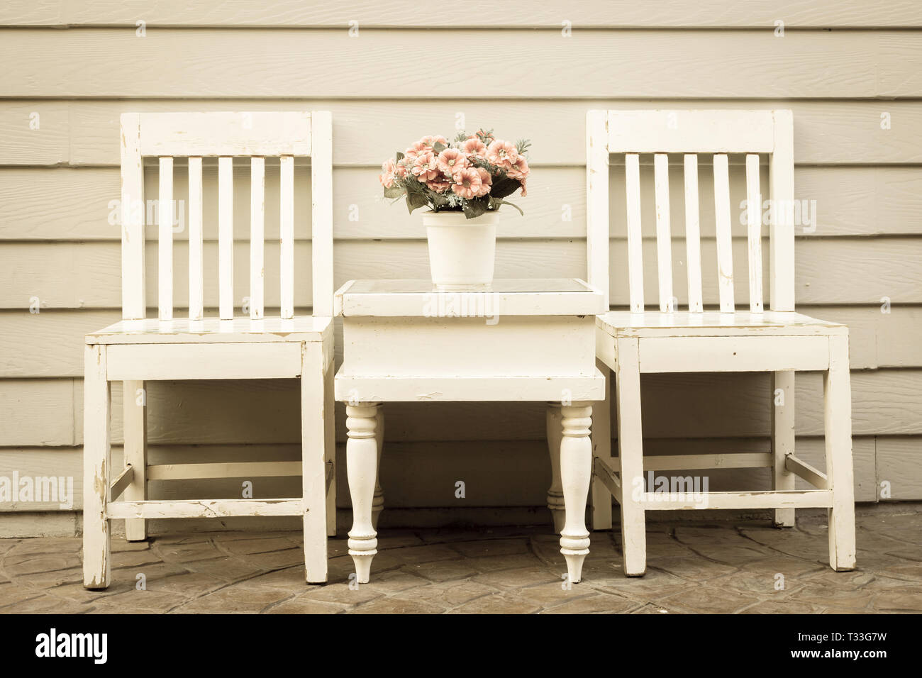 Chair and table with flowers vase,vintage style color Stock Photo - Alamy