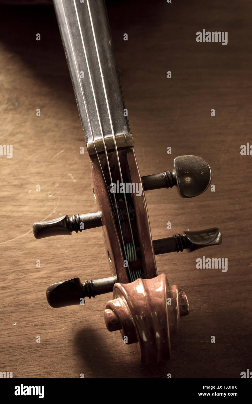 Violin neck on wooden table,vintage color style Stock Photo - Alamy