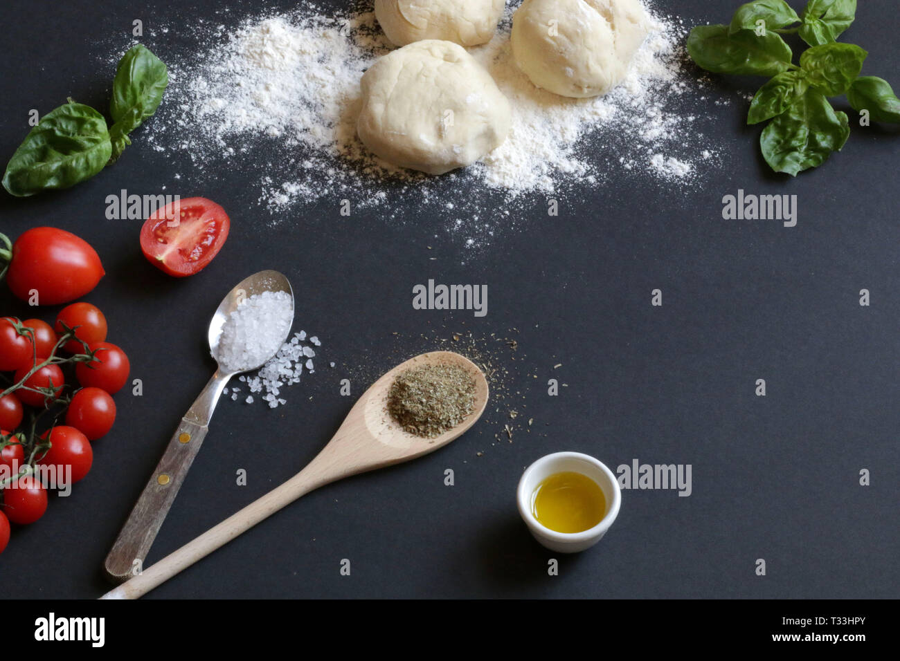 Homemade pizza. Ingredients for making italian pizza on dark background ...