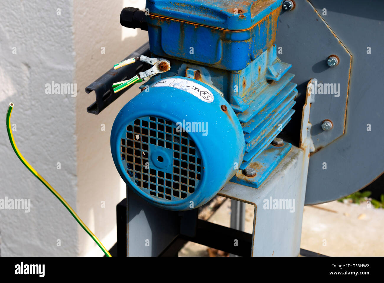 rusty electric motor outside factory building for air ventilation ...