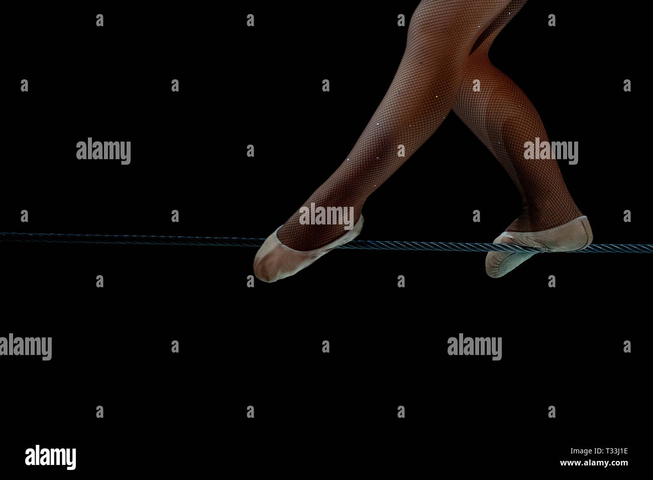 circus equilibrist steel wire artist feet detail on black background ...