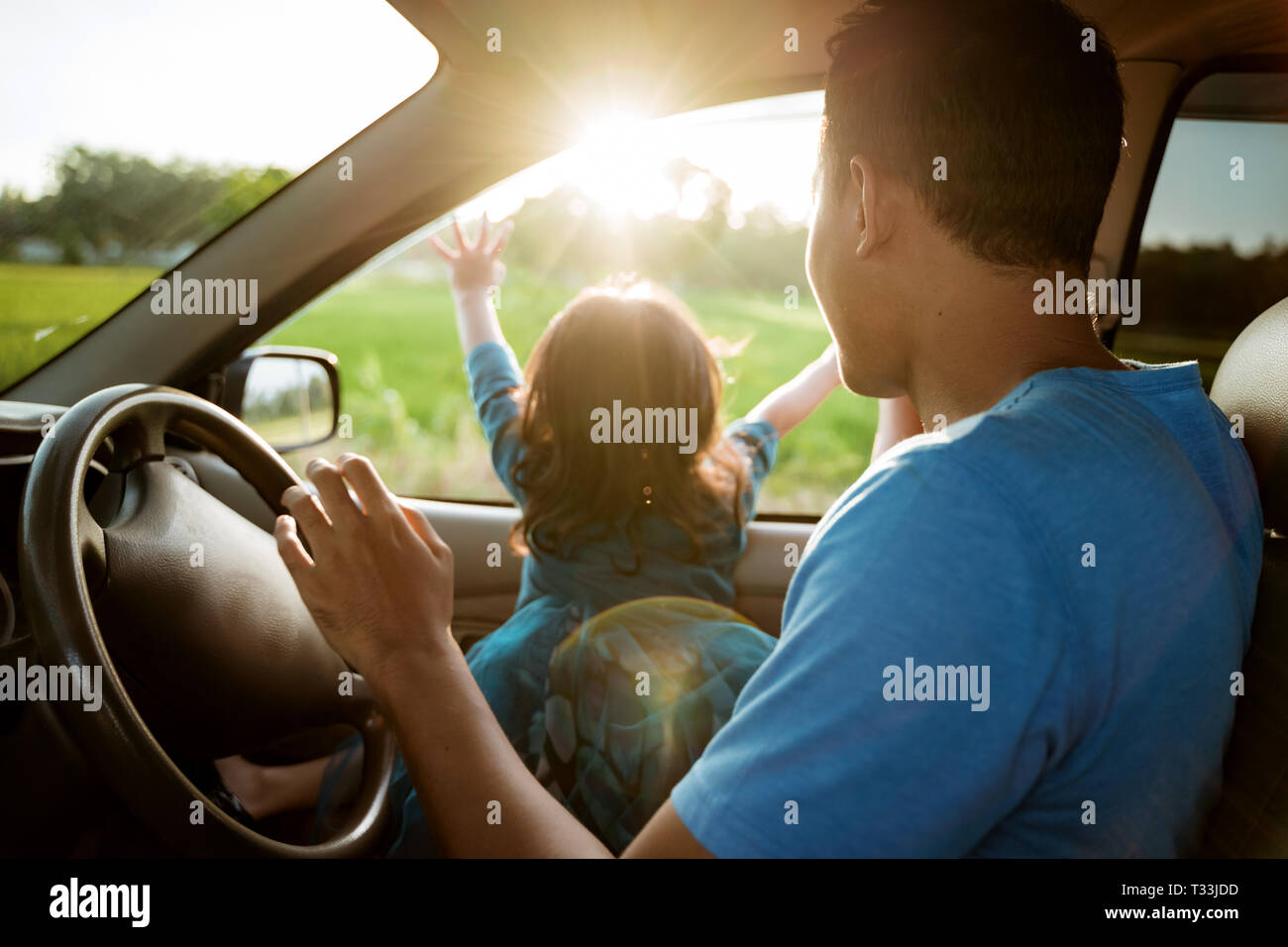 dad and daughter enjoy sunset inside car Stock Photo - Alamy