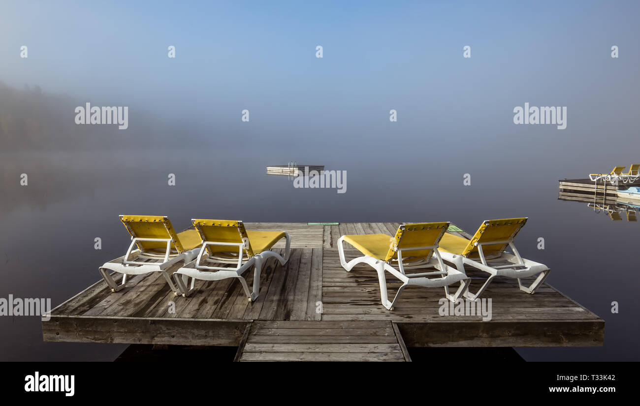 view of a boat dock the Lac-Superieur, misty morning with fog, in ...