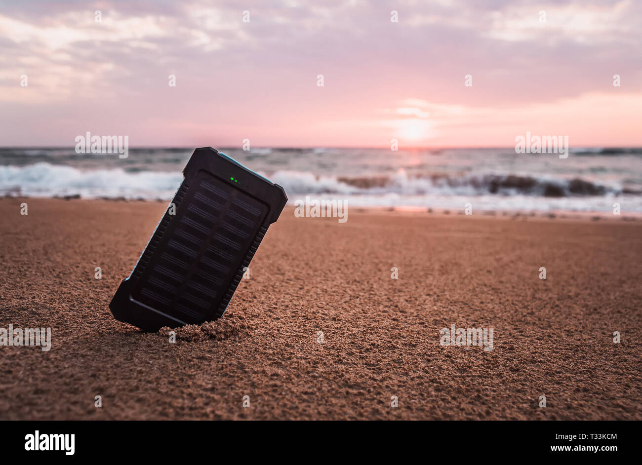 Portable solar panel is on the beach in the sand. Alternative energy ...