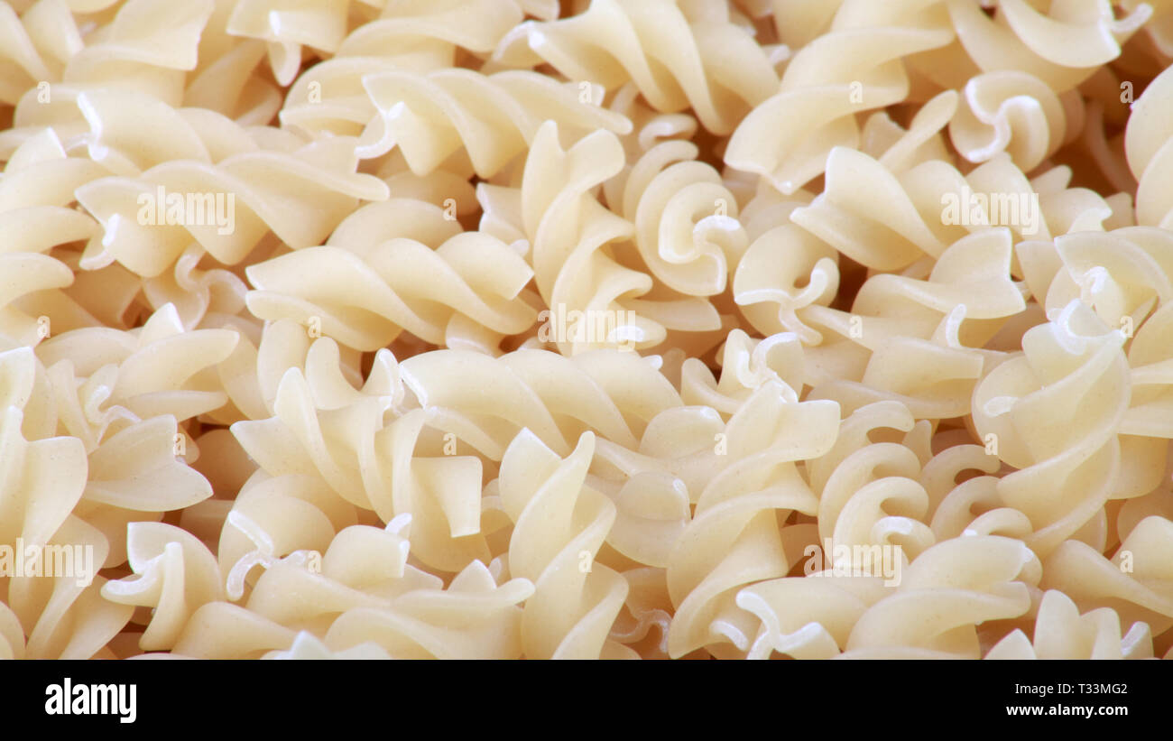 many of twist macaroni background Stock Photo - Alamy