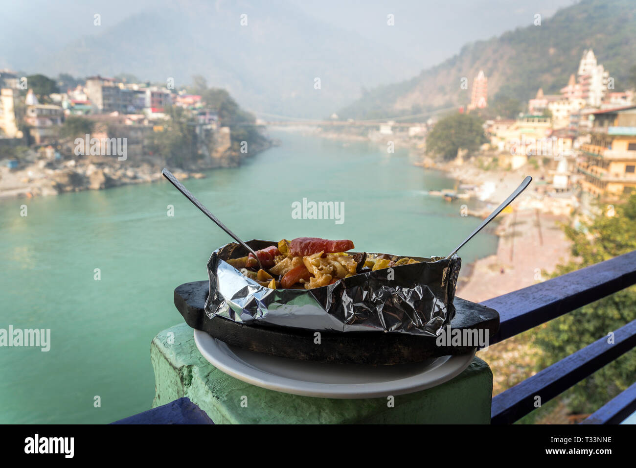 A dish of grilled and stewed vegetables on the background of the river ...