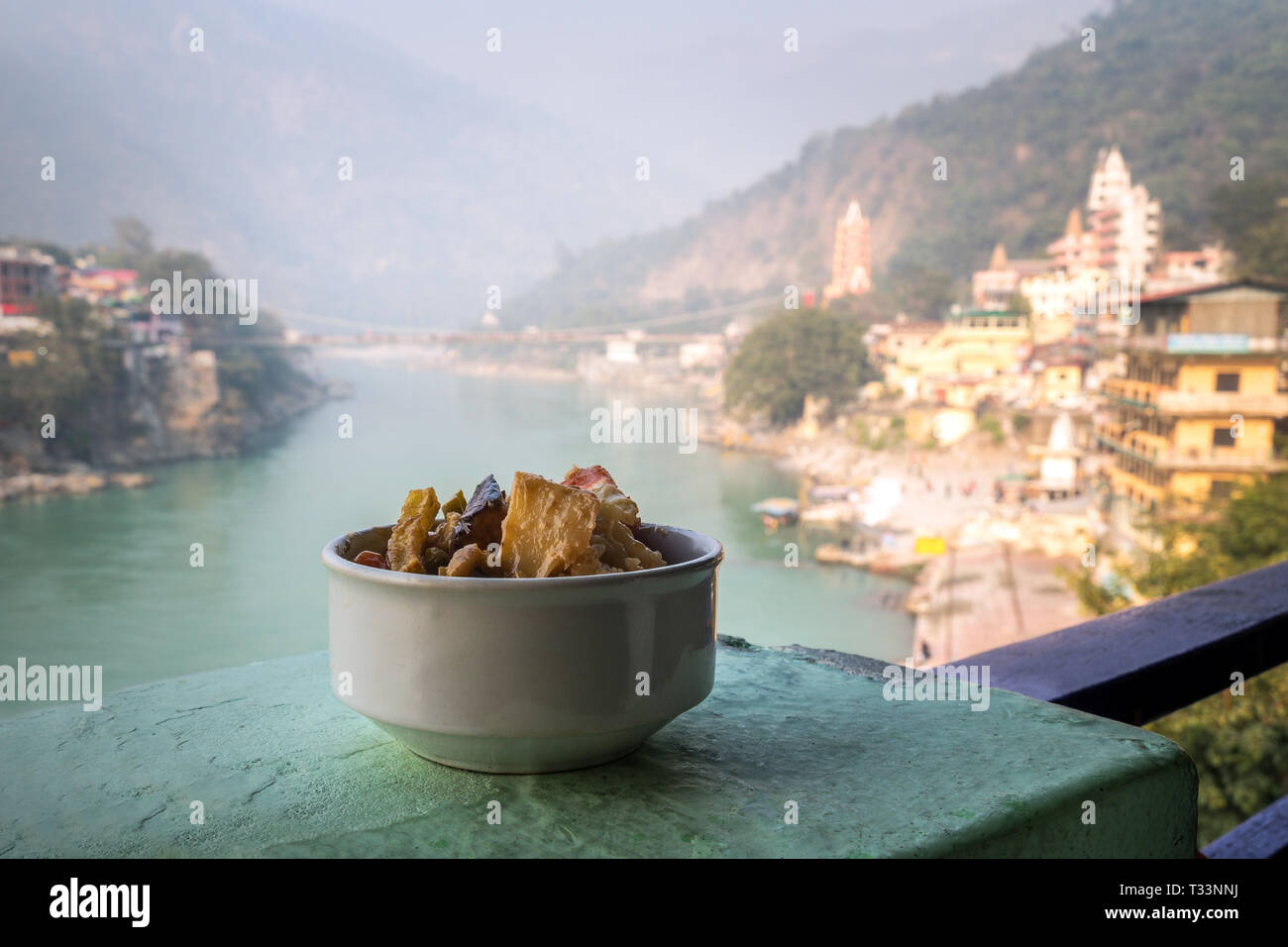 A dish of grilled and stewed vegetables on the background of the river ...