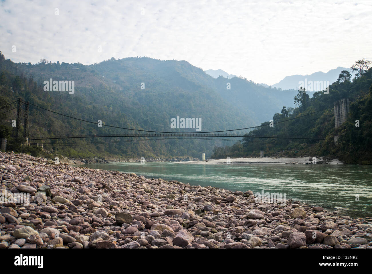 A beautiful landscape in the mountains with a bridge over the Ganges ...
