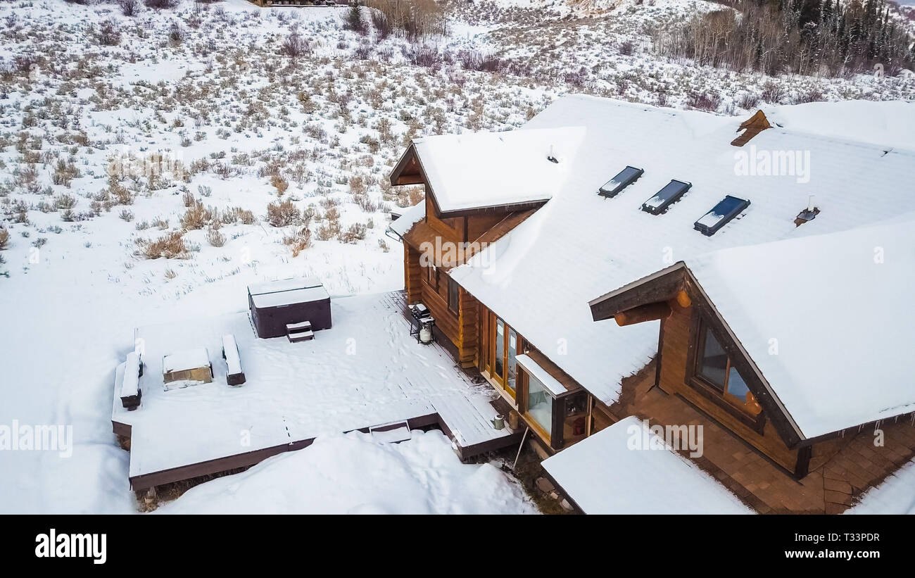 Aerial view of the mountain house covered in snow in the Winter Stock ...