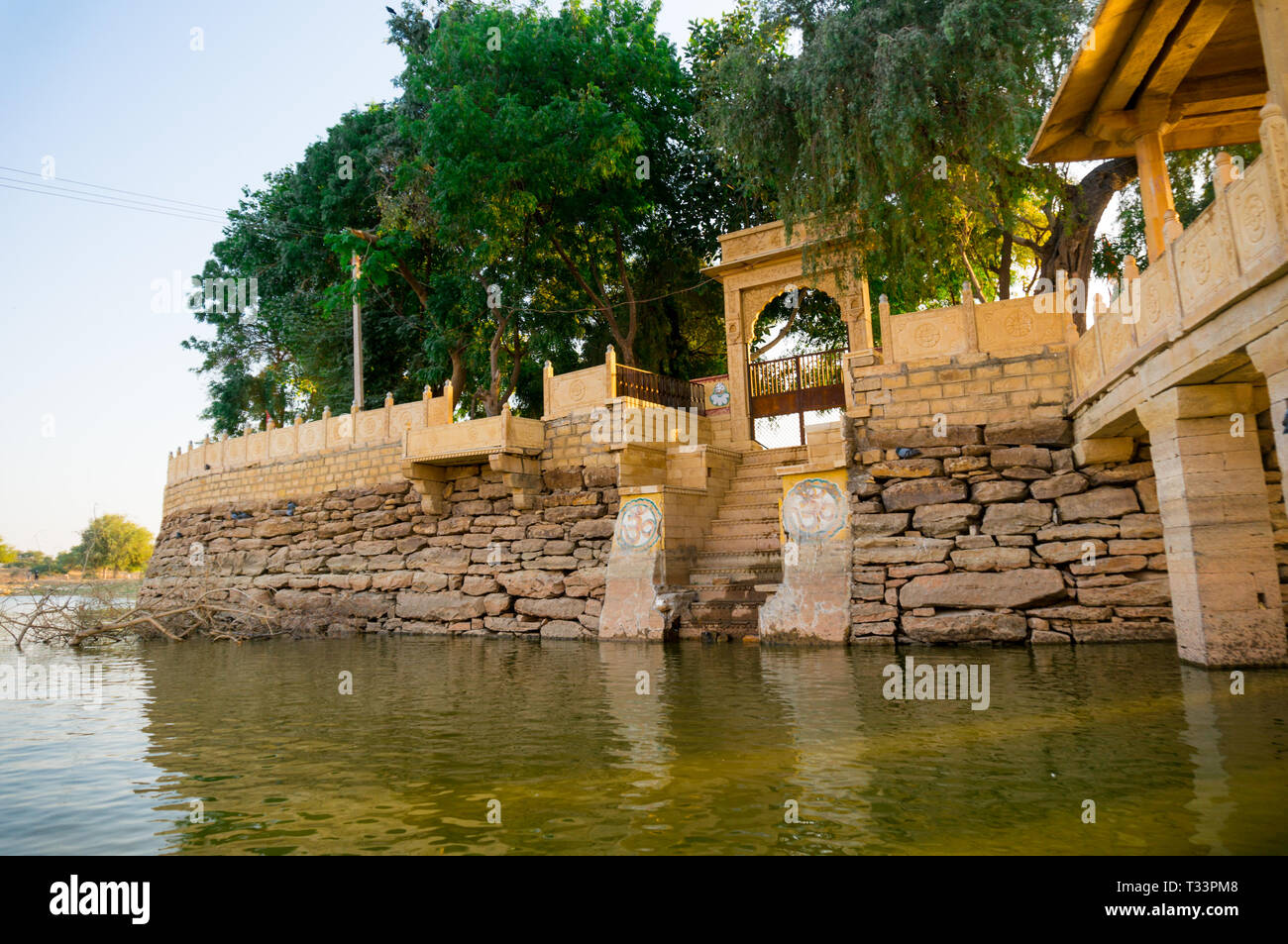 Central island park with sandstone buildings and trees growing at gadi ...