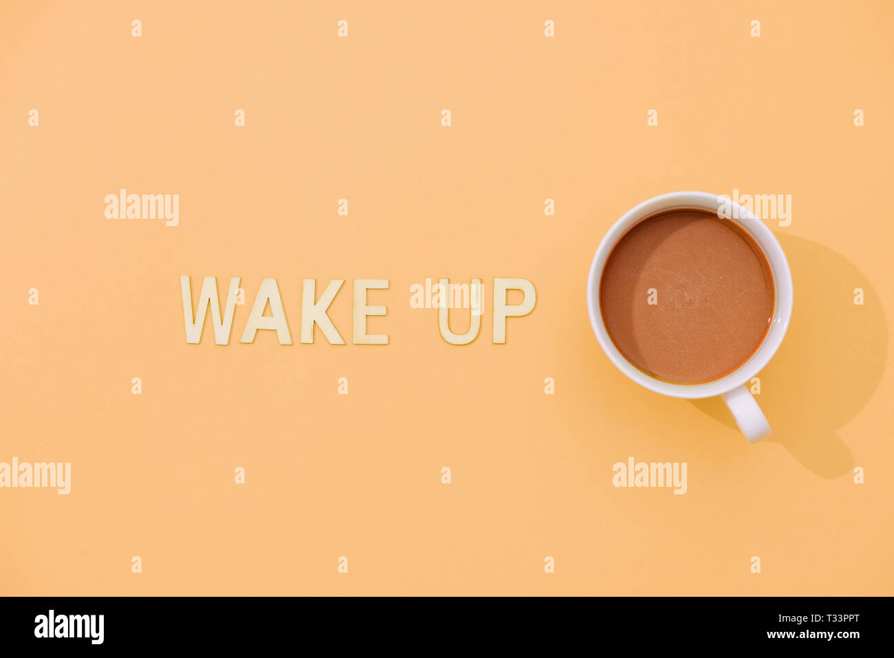 WAKE UP text with a cup of coffee with shadow on pink background Stock ...