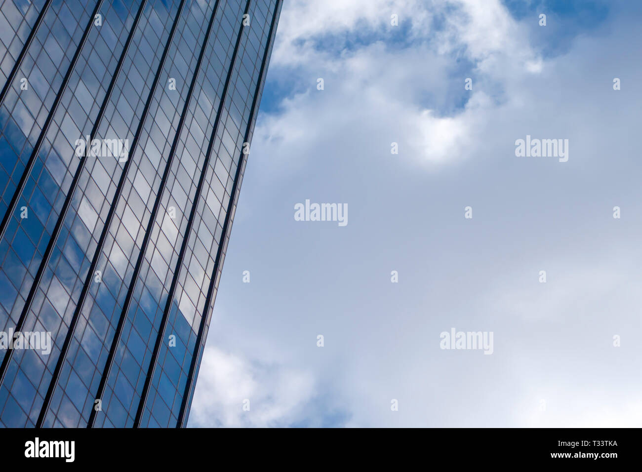 Glass windows of a skyscraper with blue sky reflections Stock Photo - Alamy