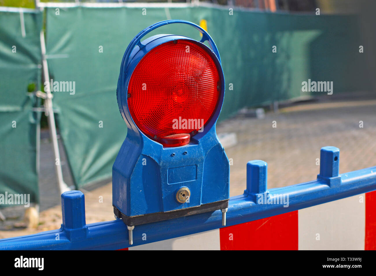 Close up of bright red reflector warning light attached to blue ...