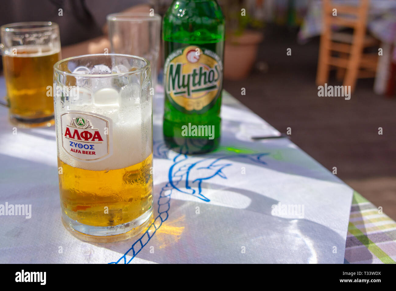 CRETE, GREECE - May 2, 2015: Mug with beer in traditional Greek tavern ...