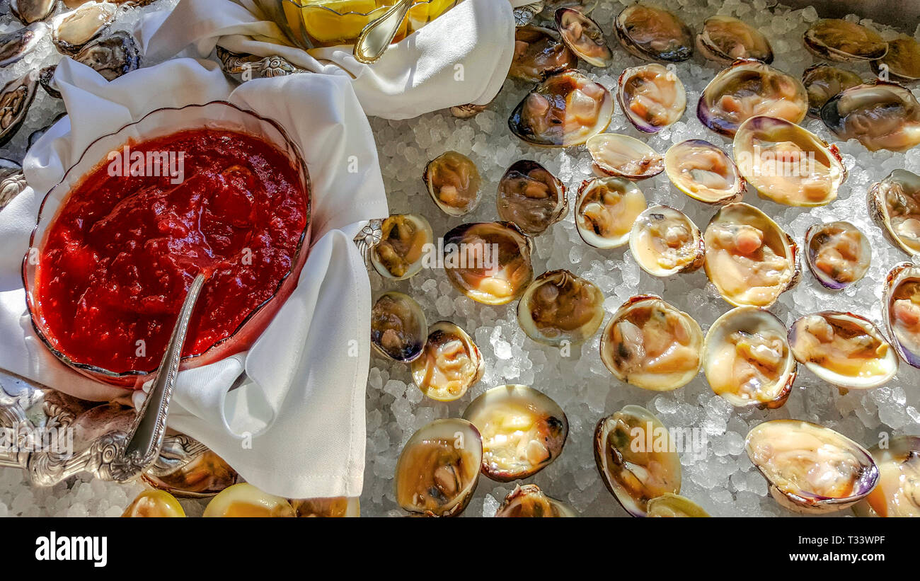 Clams on a halfshell on a bed of ice and ready to be served raw to ...