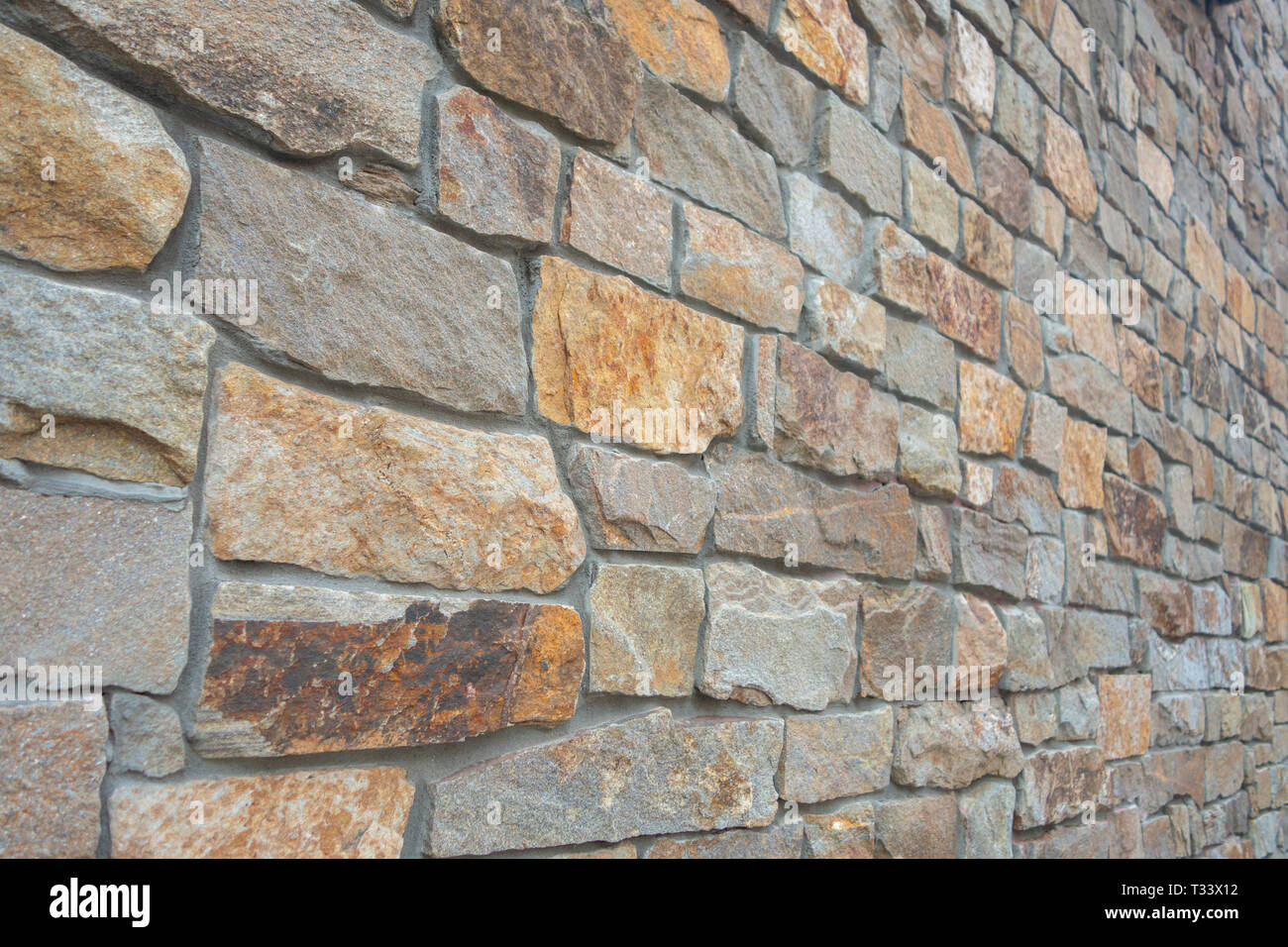 Cement band stone wall at an angle view Stock Photo - Alamy