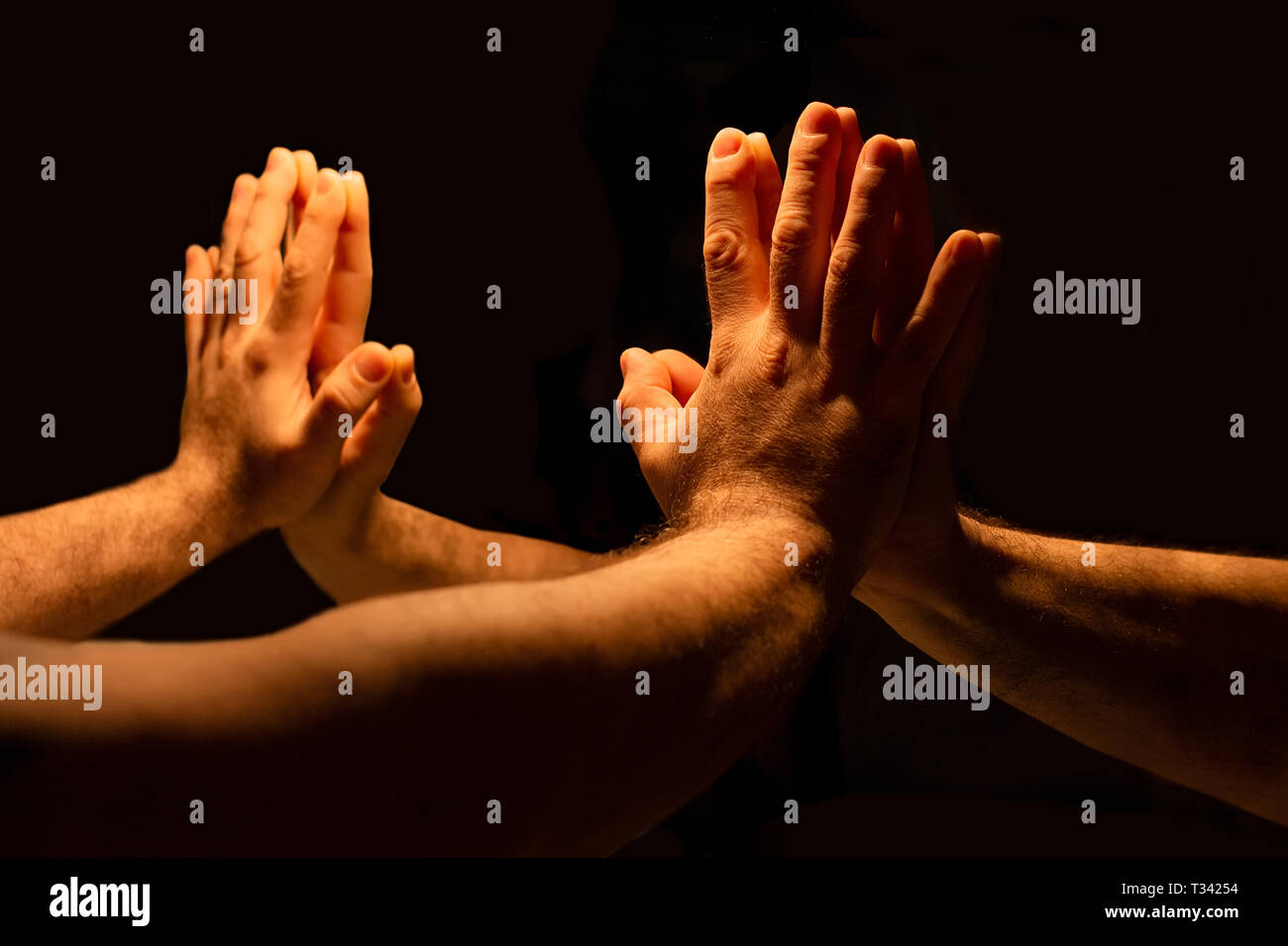 Reflection of strong male hands, palm on palm, concept of strength and ...