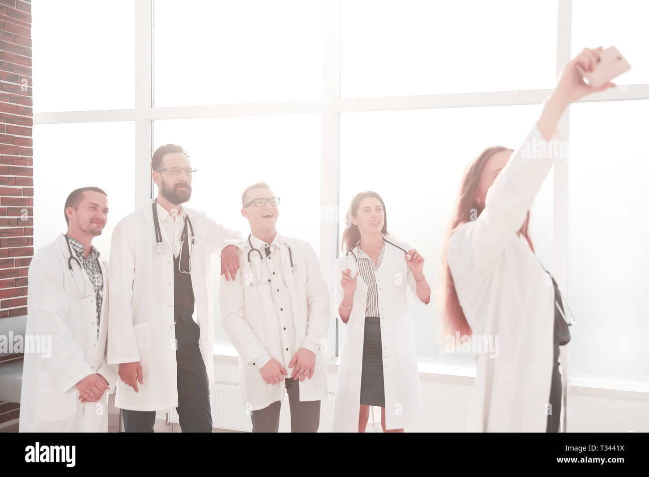 team of doctors at the medical center taking a selfie Stock Photo - Alamy
