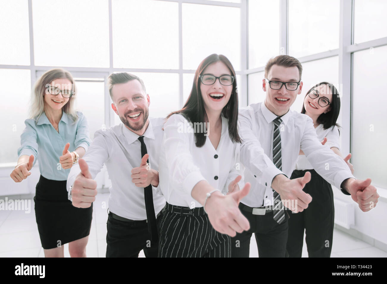 fun business team showing their thumbs up Stock Photo - Alamy