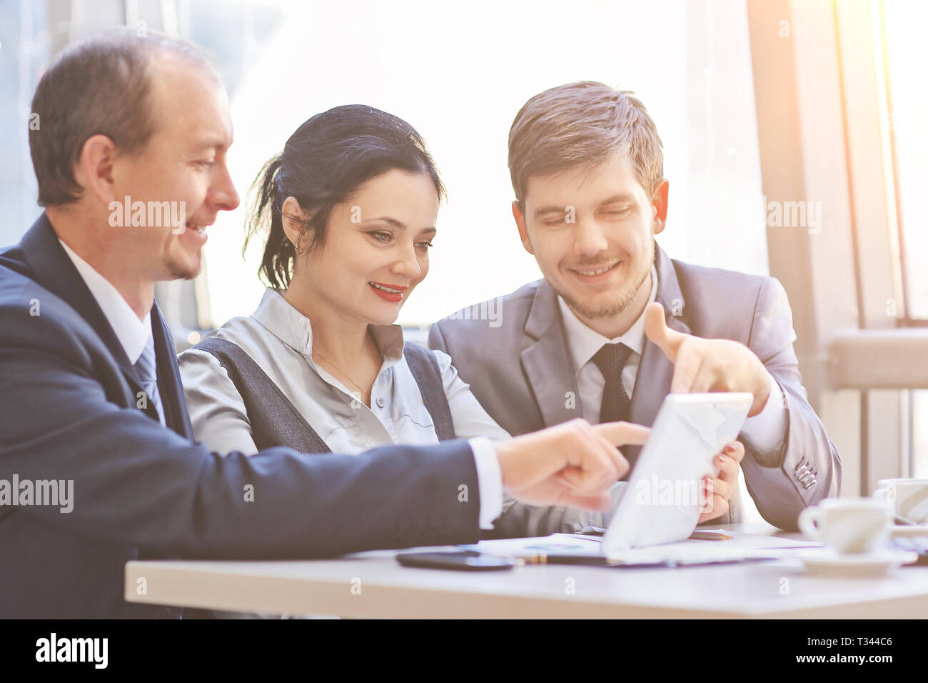 Business team using tablet touchpad for meeting to discuss statistical ...