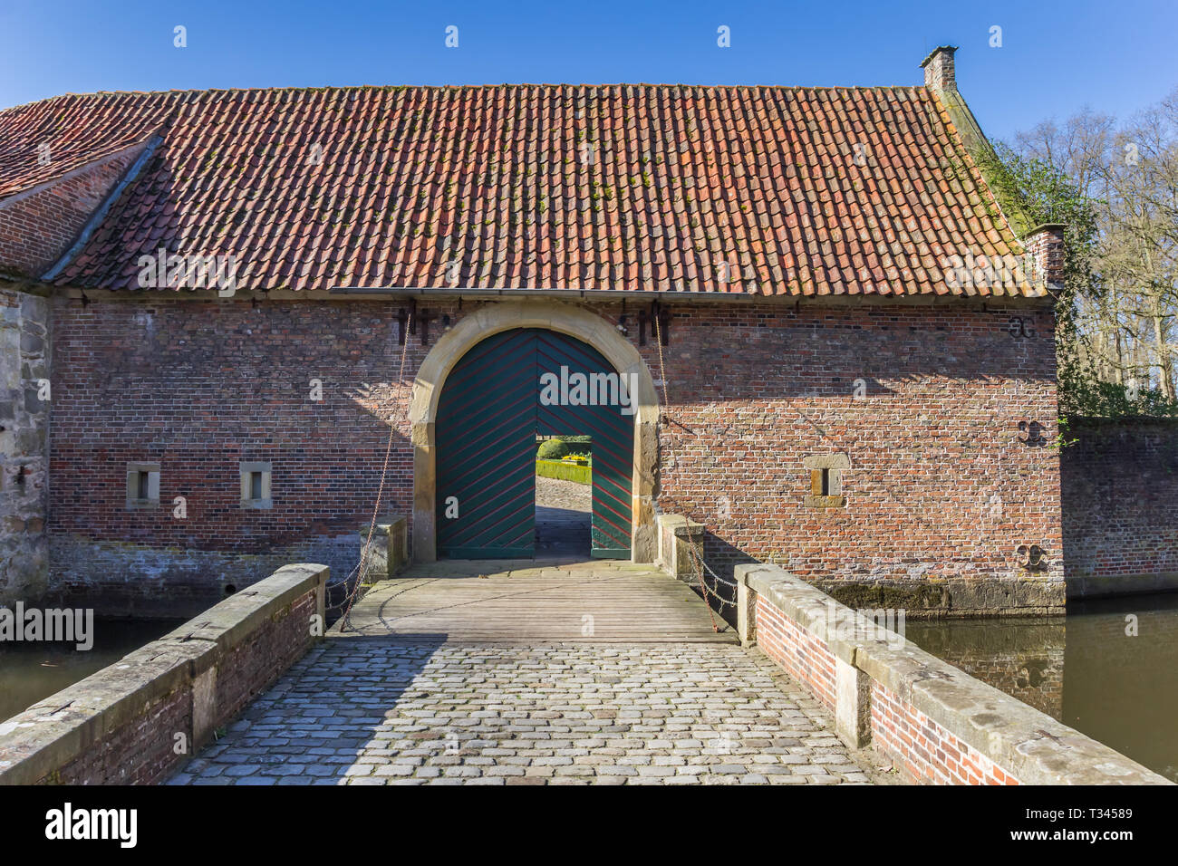 Bridge and main entrance to the historic house Welbergen in Ochtrup ...