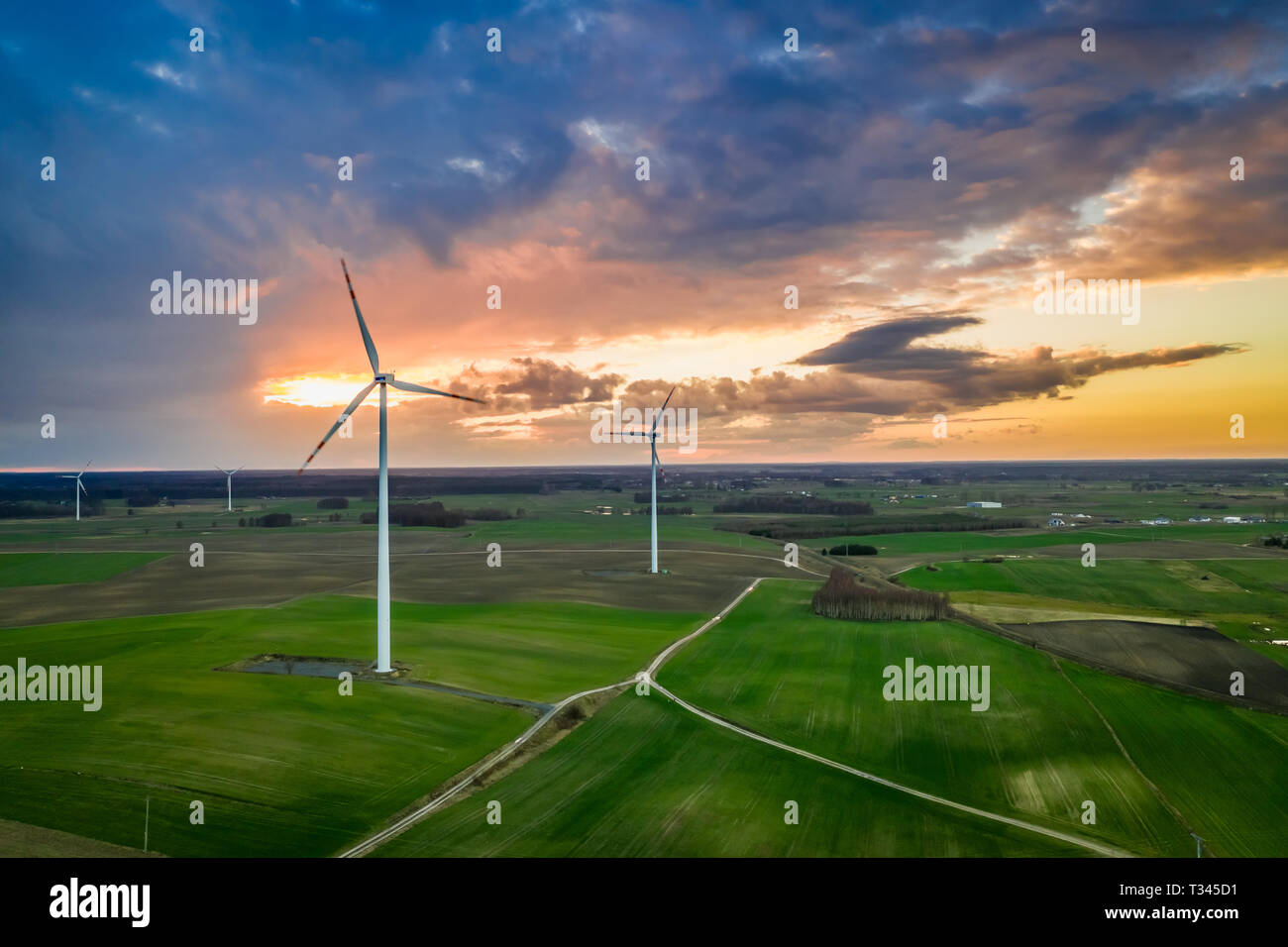 Flying above stunning wind turbines at sunset Stock Photo - Alamy