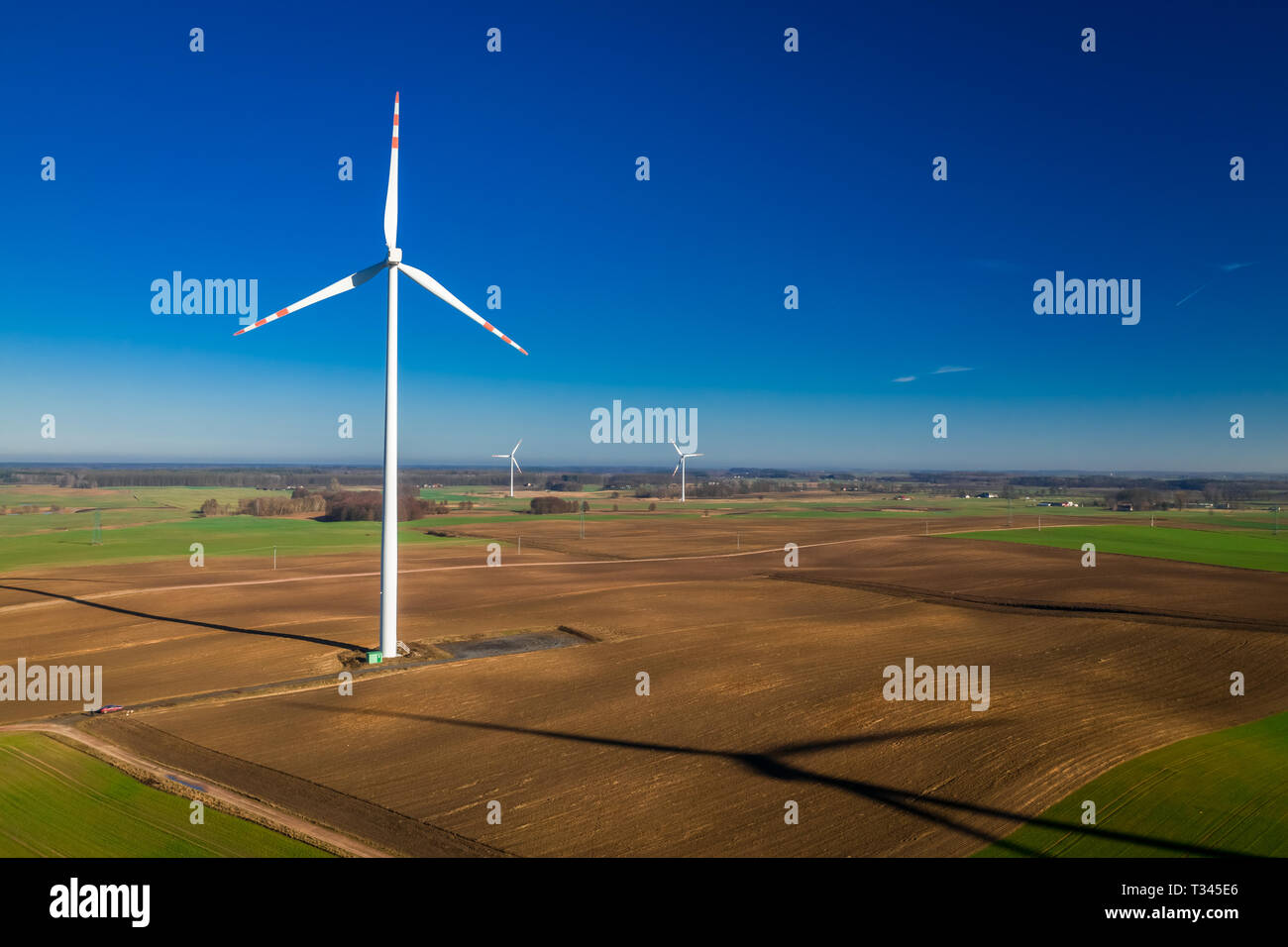 Flying above ecological wind turbines in a field Stock Photo - Alamy