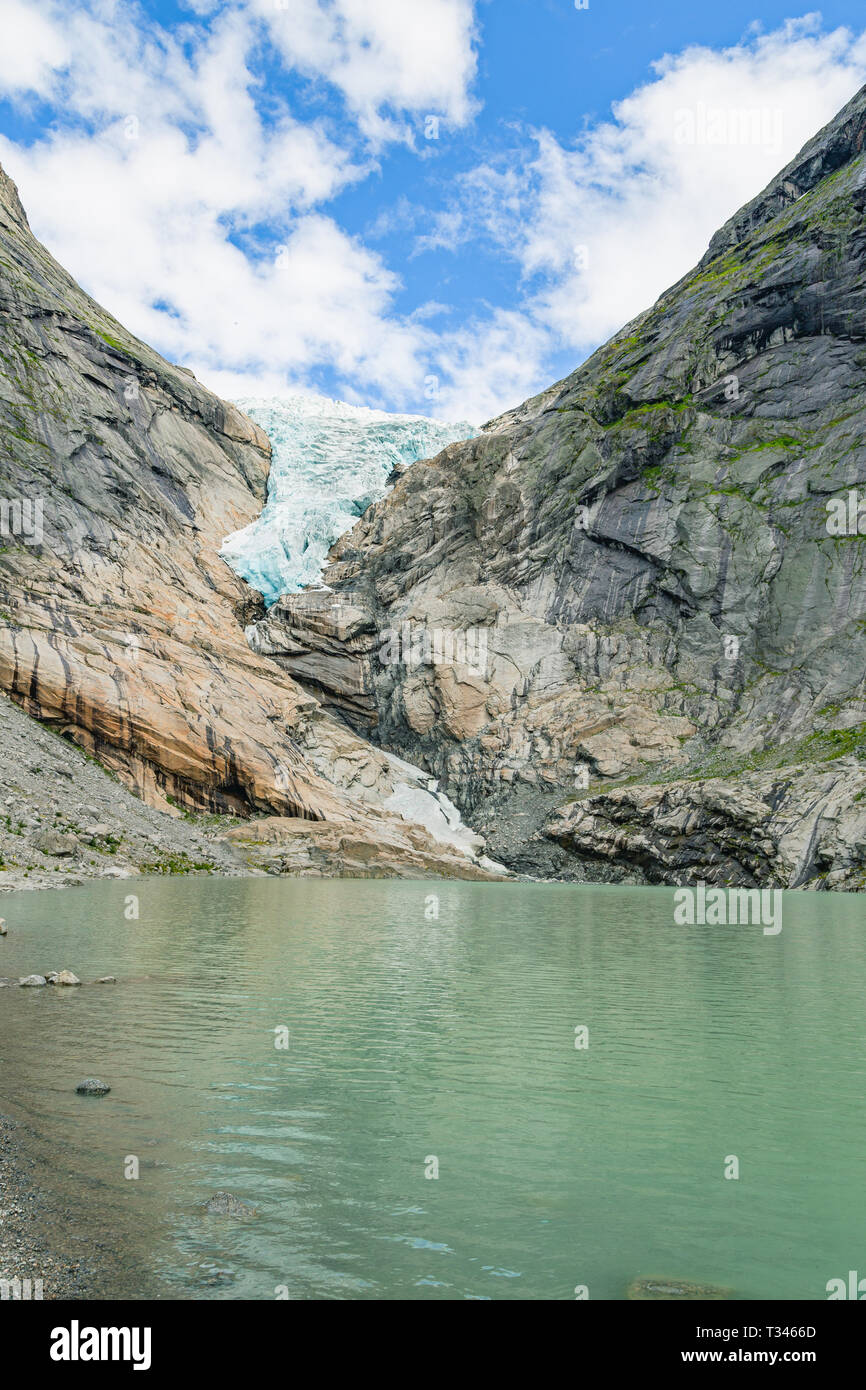 Melting Briksdal glacier in Norway, close up. Panorama from bottom to ...